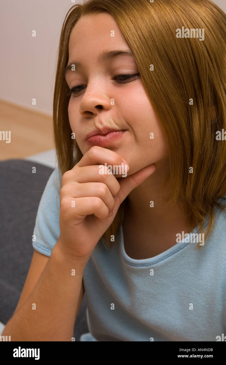 Portrait of a young girl thinking Stock Photo - Alamy
