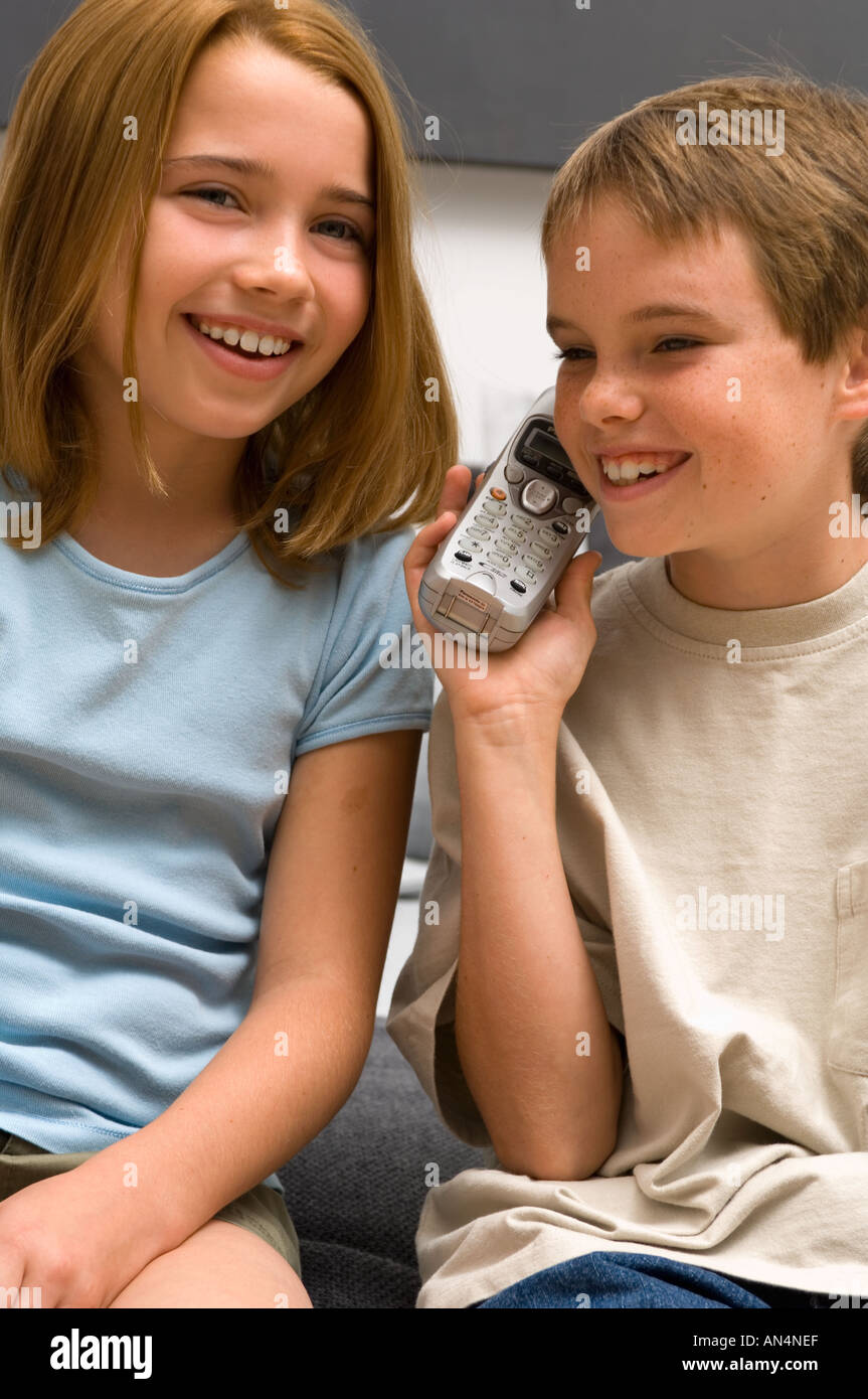 Portrait of two young kids talking on the same telephone Stock Photo ...