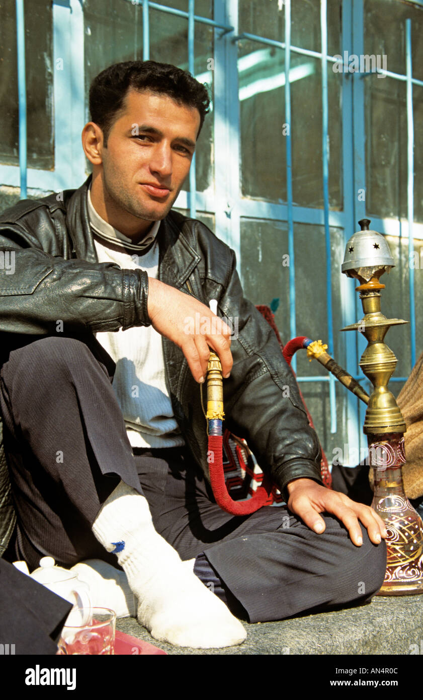 A young man smoking hookah at a park in Tehran Iran Stock Photo - Alamy