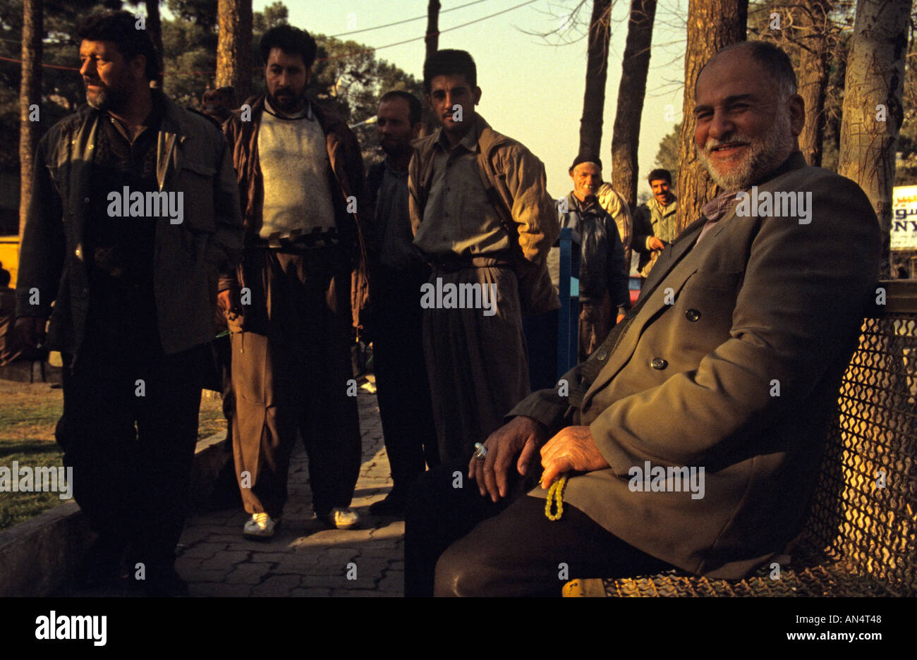 An Armenian man sitting on a bench next to a group of men Tehran Iran ...