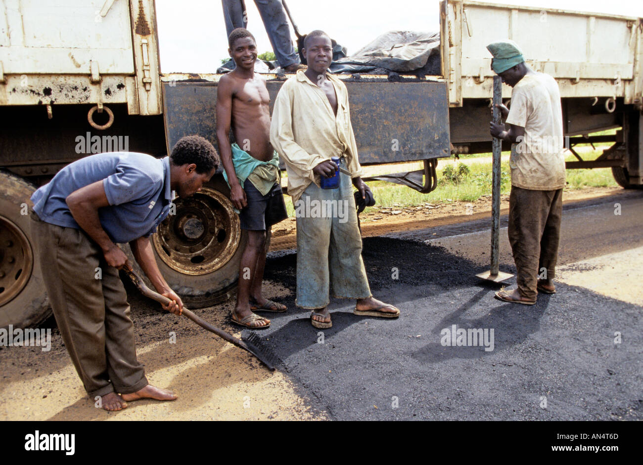 Workers repairing road with tar Stock Photo - Alamy