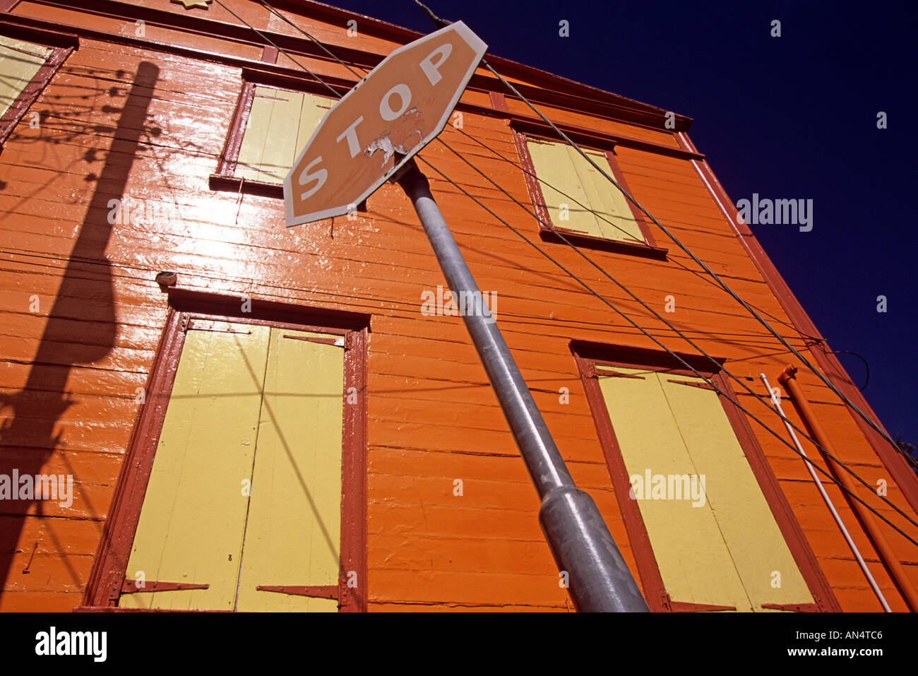 A stop sign in front of a house in a city Stock Photo - Alamy