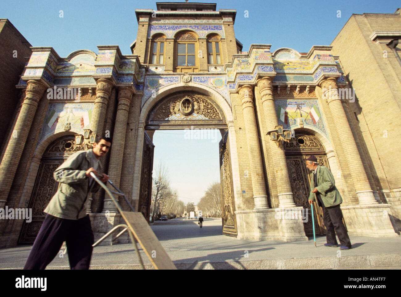 Pedestrians walking past and standing in front of Shah's Palace, Tehran ...