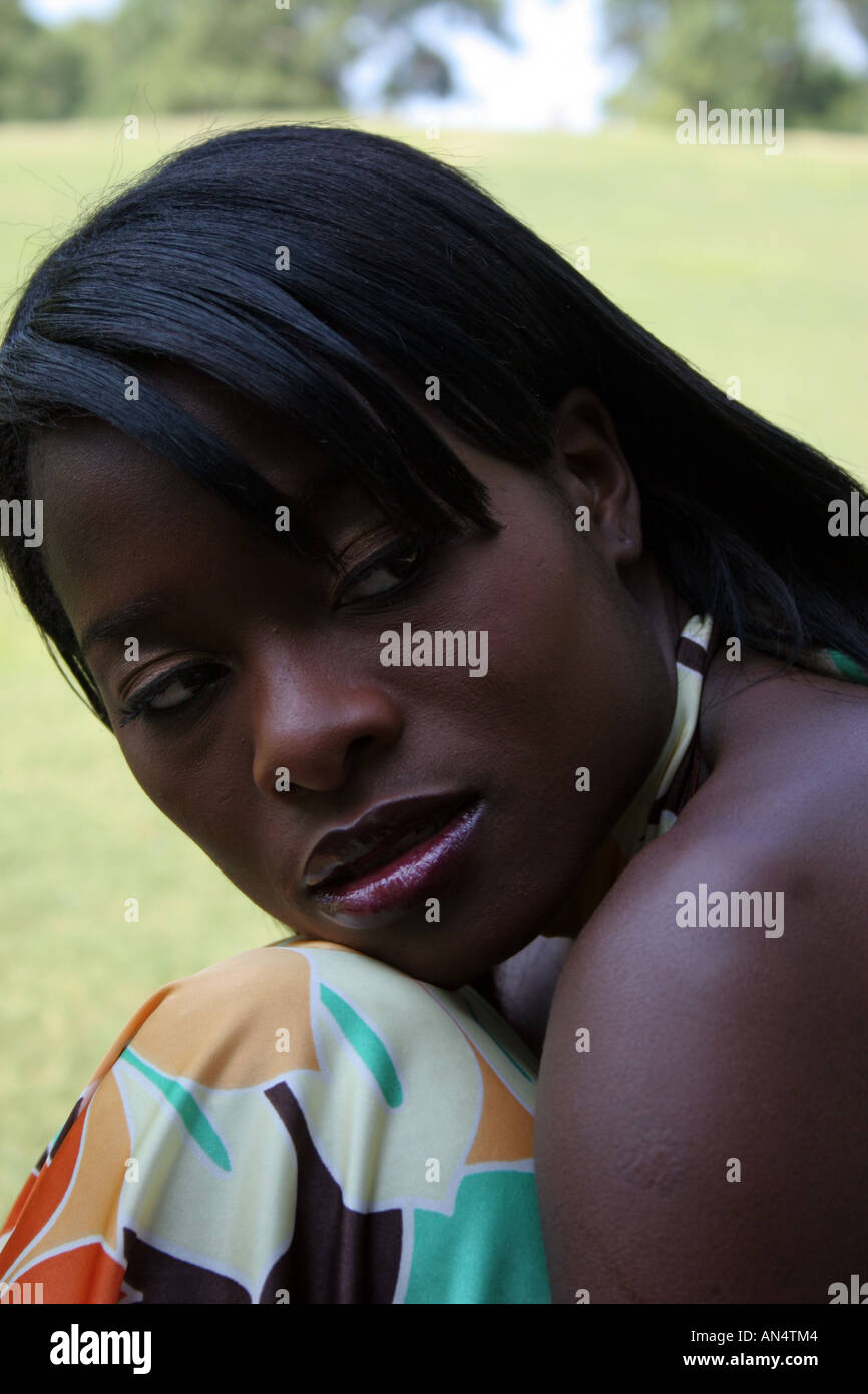 Woman resting head on knees hi-res stock photography and images - Alamy