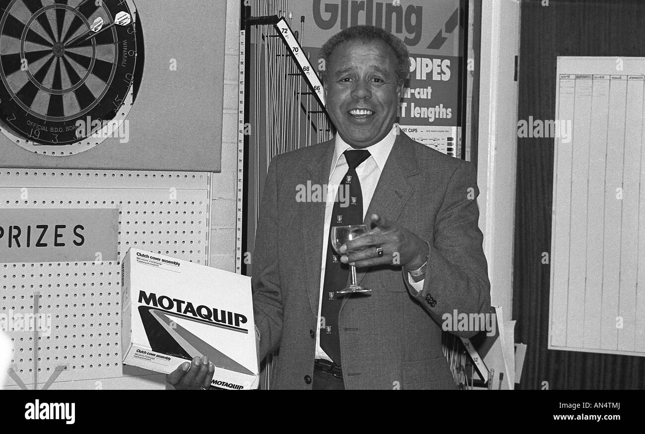 Charlie Williams with wine drink whilst opening car spares depot Stock ...