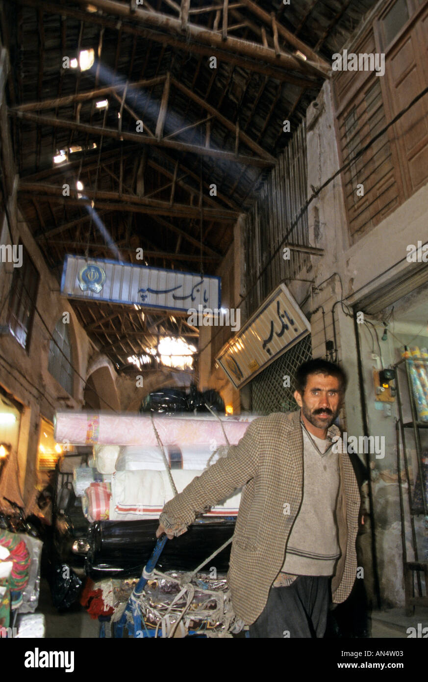 A man pulls his cart along an alley at a bazaar in Tehran Iran Stock ...