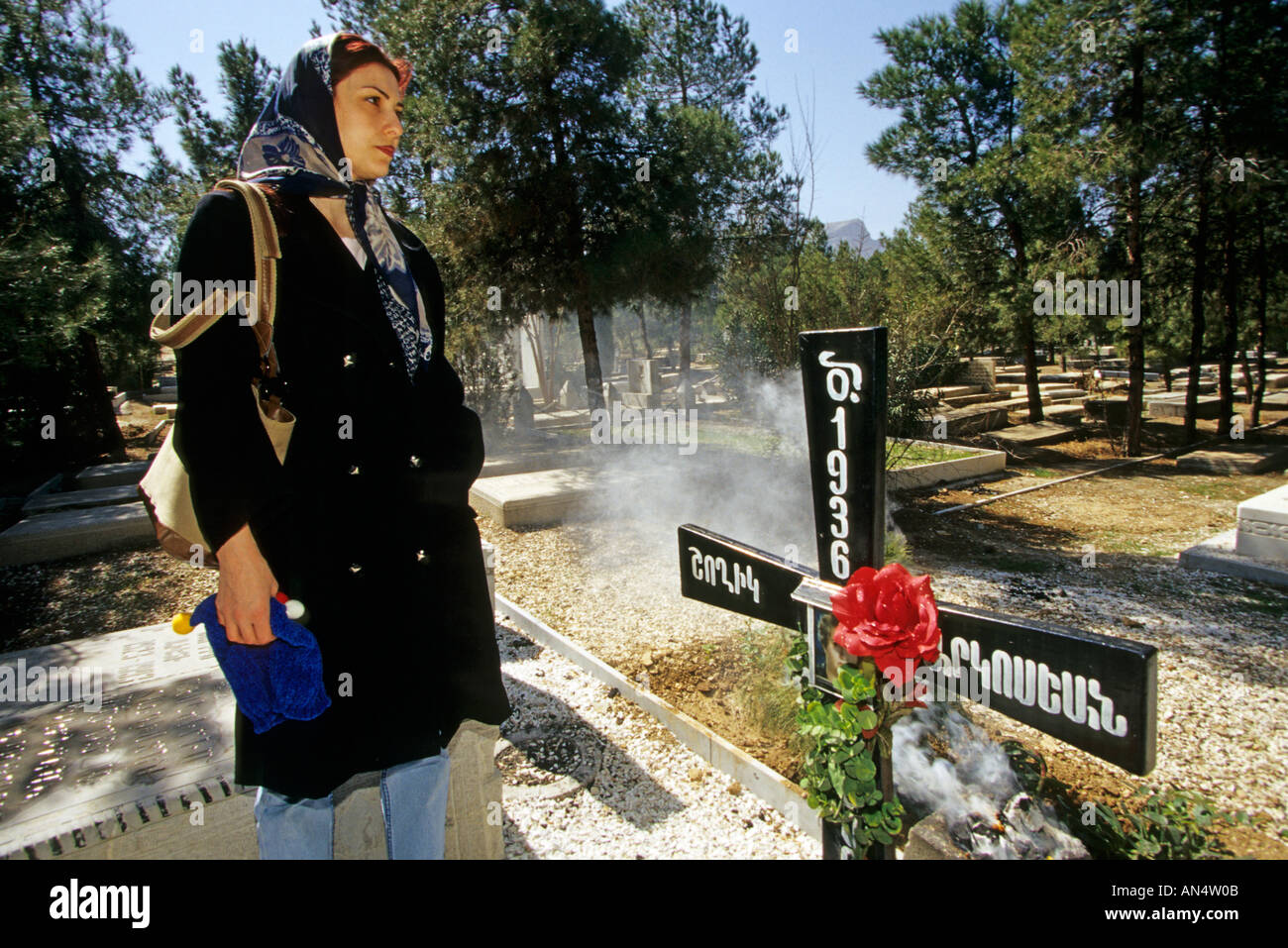 Woman paying respects to deceased loved one in graveyard Stock Photo ...