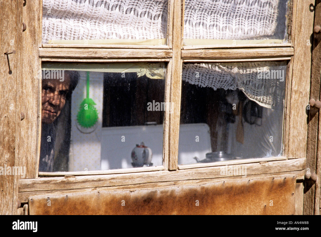 Armenian woman peeking out of window of house, Esfehan, Iran Stock ...