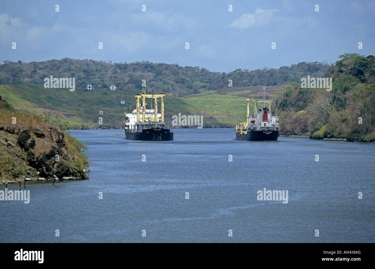 Small freighter ships make a daylight passage through the Panama Canal ...