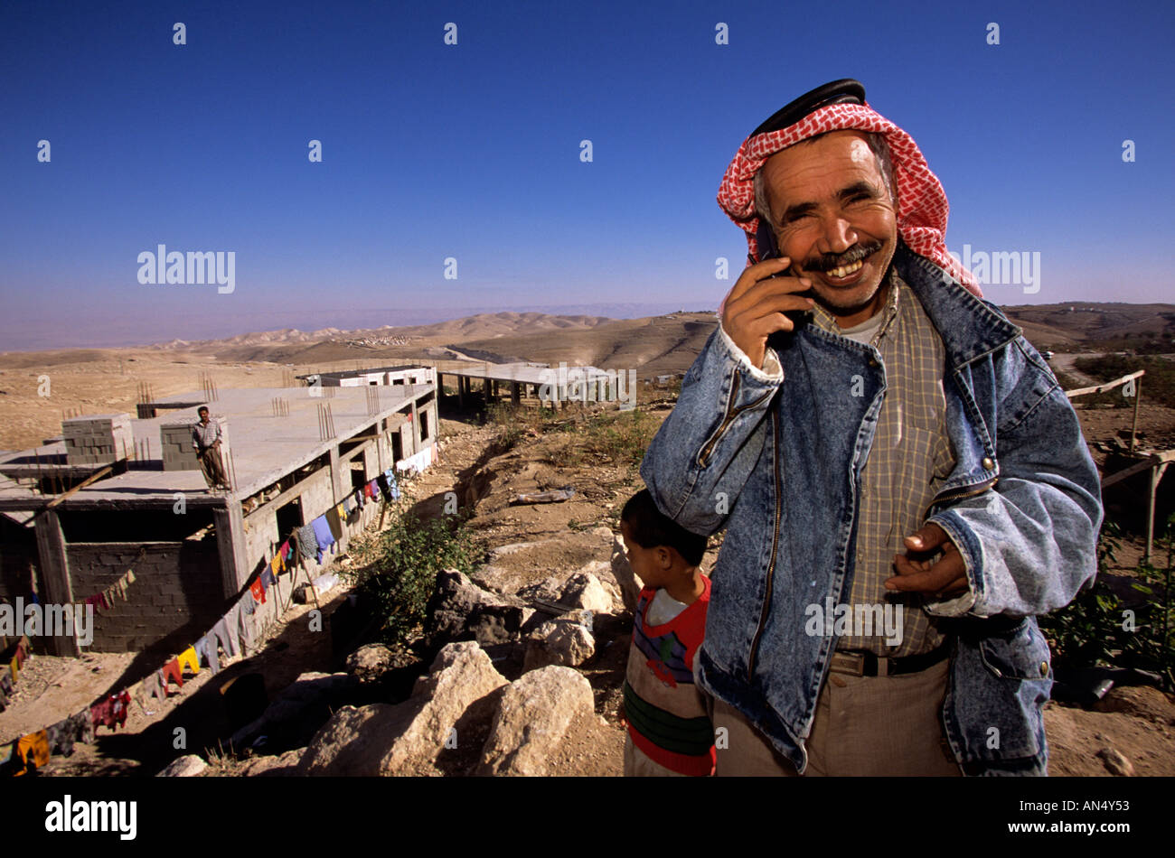 Bedouin man using mobile phone at encampment, Jerusalem Stock Photo - Alamy
