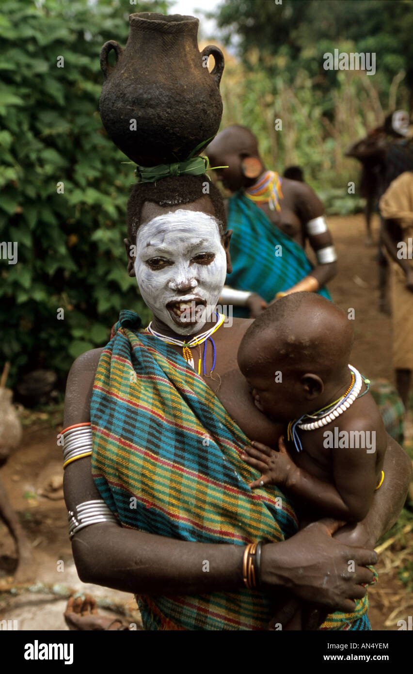 Local scene in a Surma village A mother breastfeeds her baby while ...