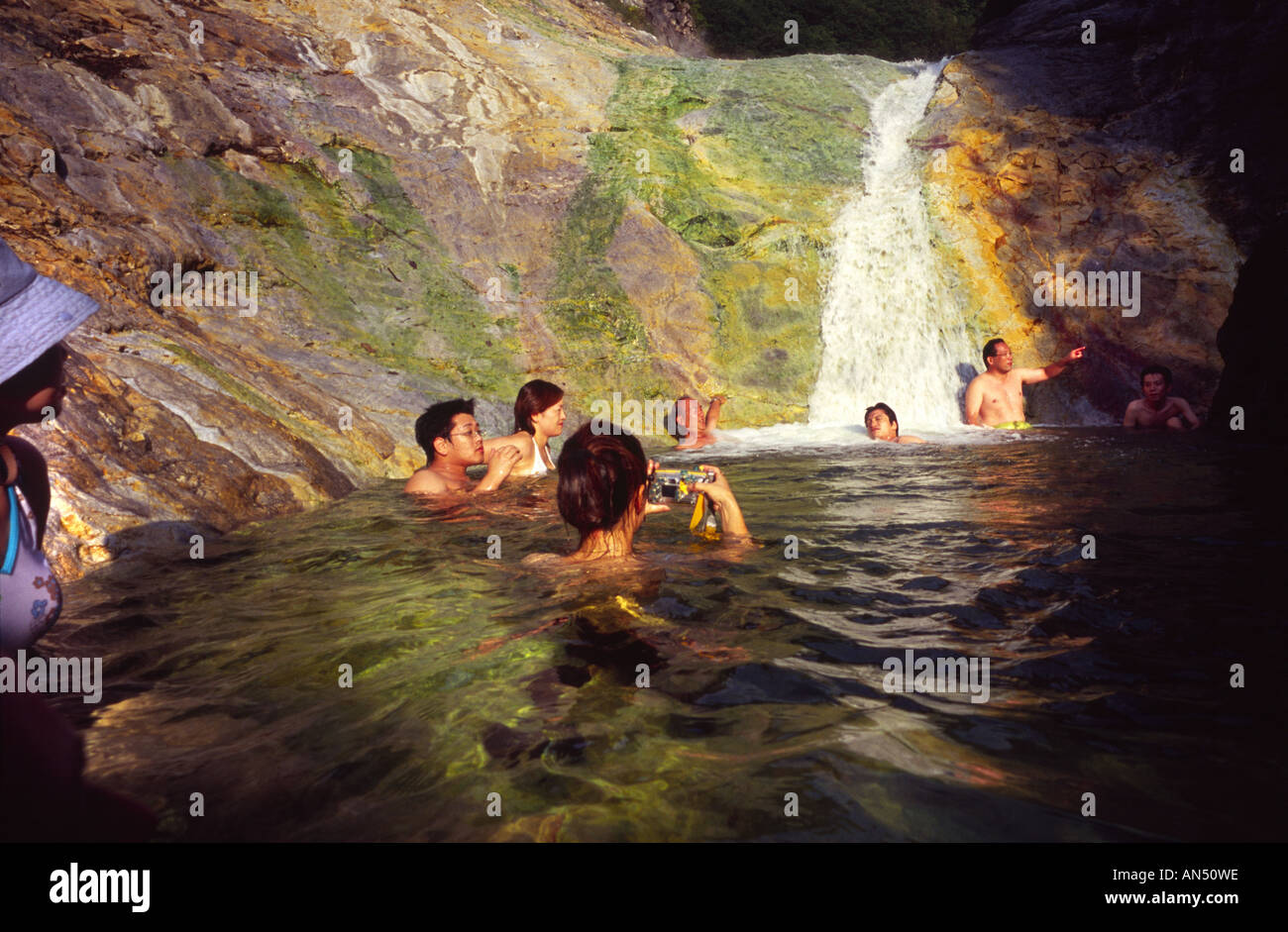 Bathers at the hot springs and waterfall at kamuiwakka-yu-no-taki ...
