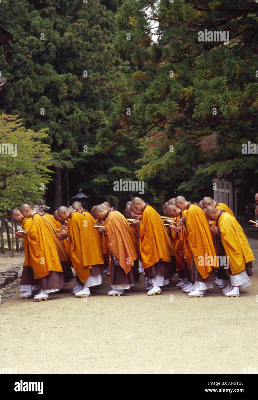 Monks bow towards a temple in the sacred square, Garan, at Koya-san ...