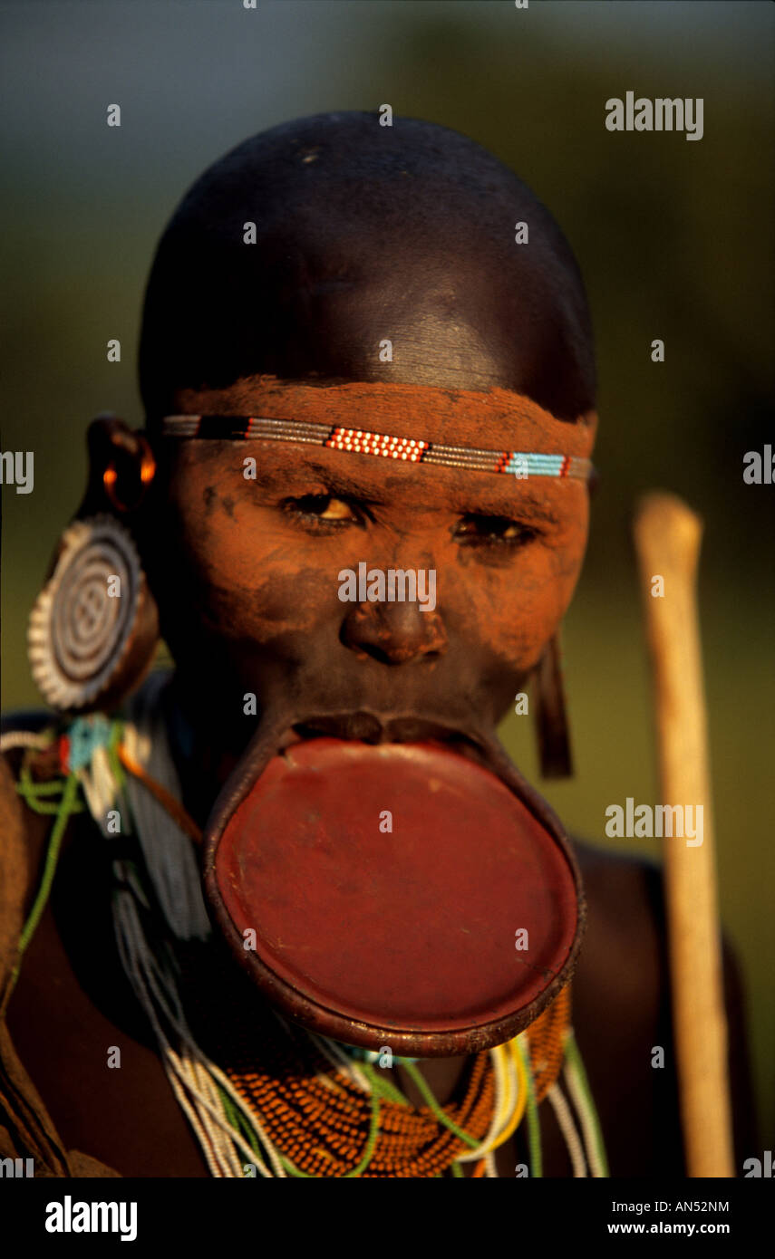 A young Surma woman wearing the traditional clay plate in her lower lip ...