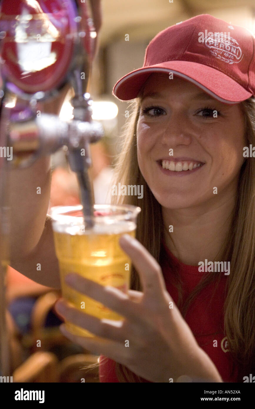 young smiling girl serving beer Stock Photo - Alamy