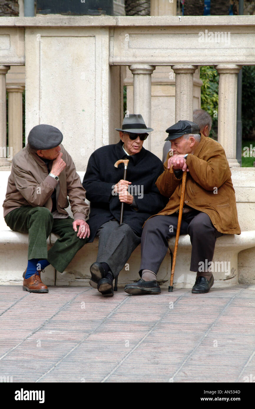 Three Spanish Men seated talking in the Street Alicante Spain Europe ...