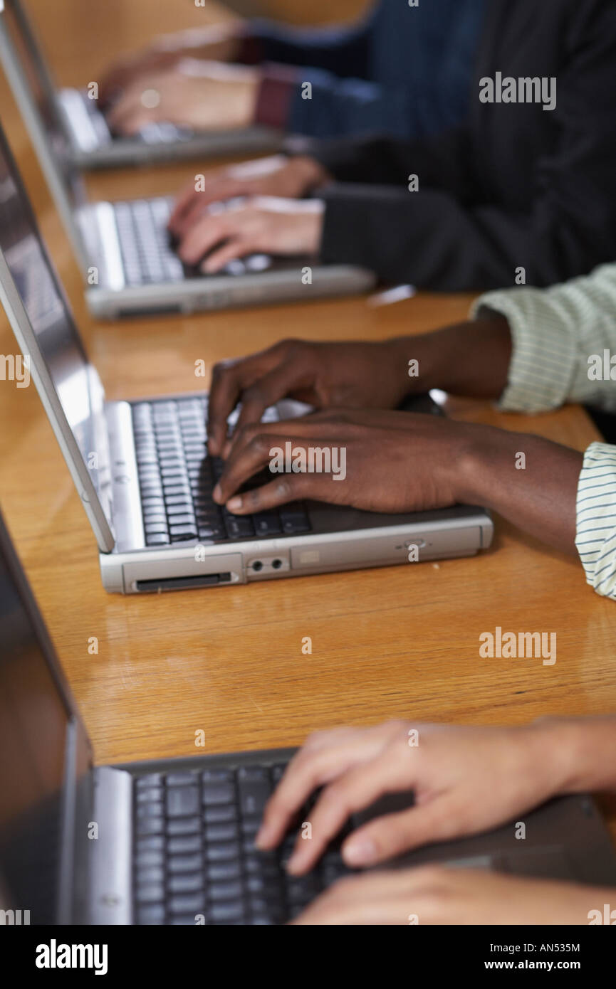 Multi-ethnic people typing on laptops Stock Photo - Alamy