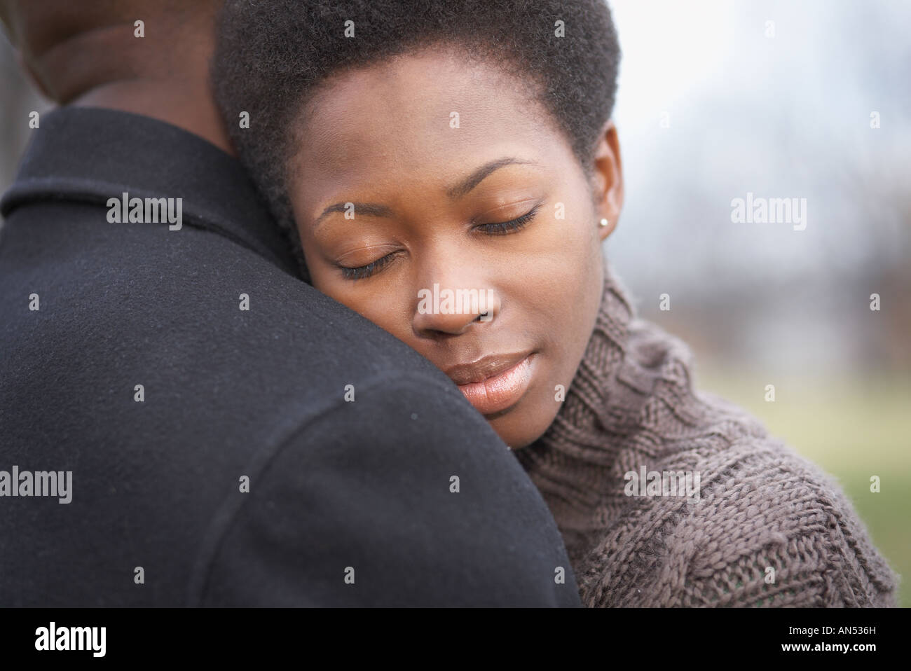 Close up of African couple hugging Stock Photo - Alamy