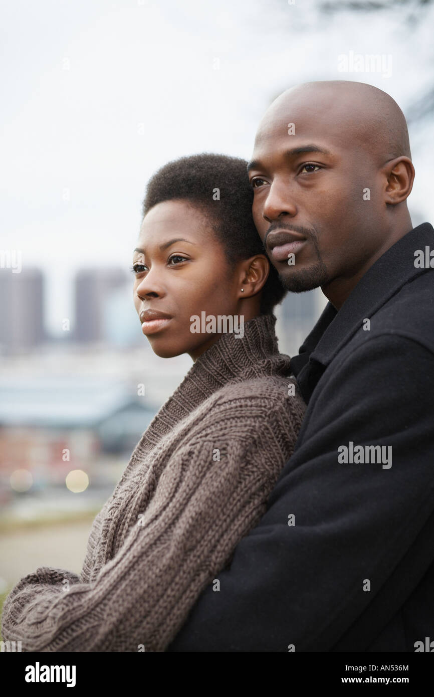 Portrait of African couple hugging Stock Photo - Alamy