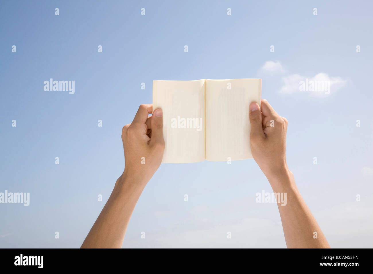 Hands holding up a book Stock Photo - Alamy