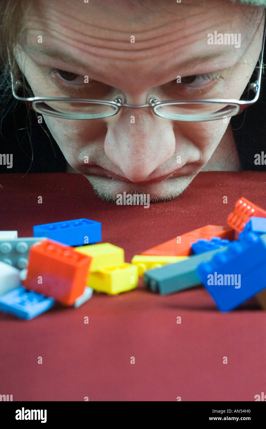 man playing with lego Stock Photo - Alamy
