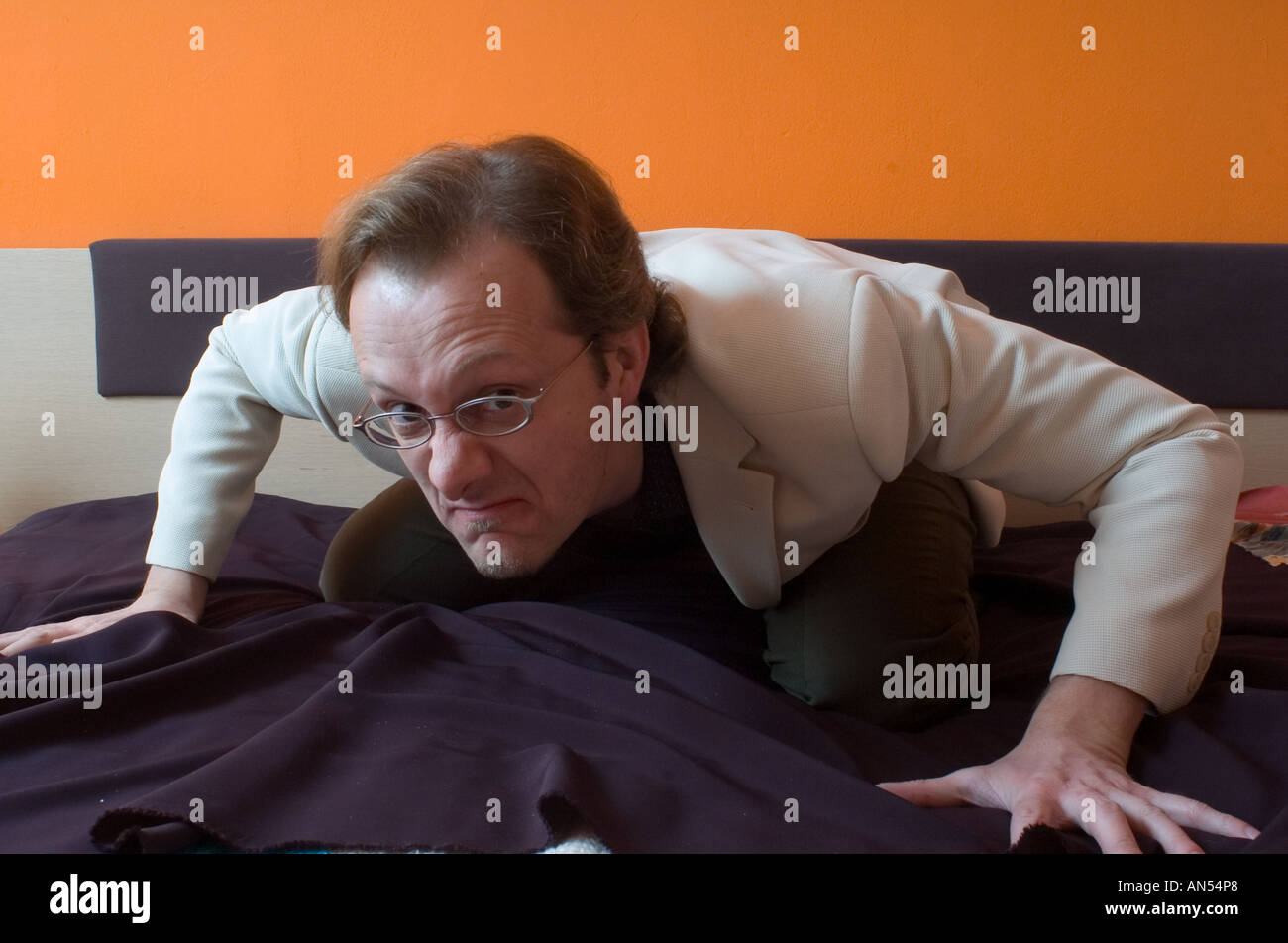 angry man crawling on bed Stock Photo - Alamy