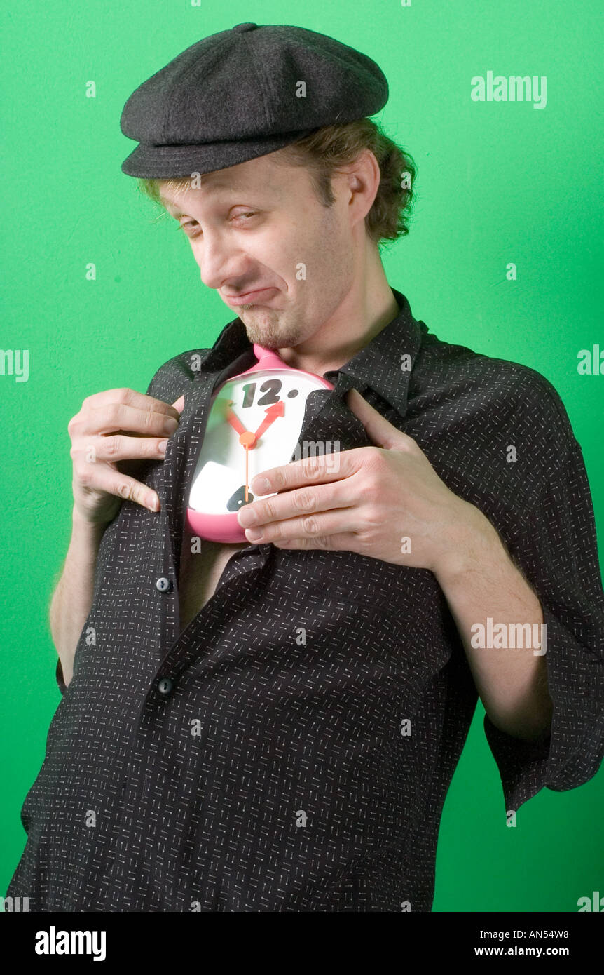 man hiding watch under shirt on his chest Stock Photo - Alamy
