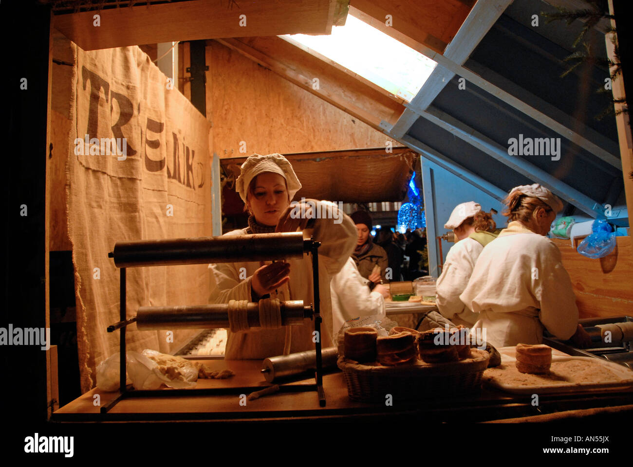 A vendor preparing Trdelník a kind of spit cake made from rolled dough ...
