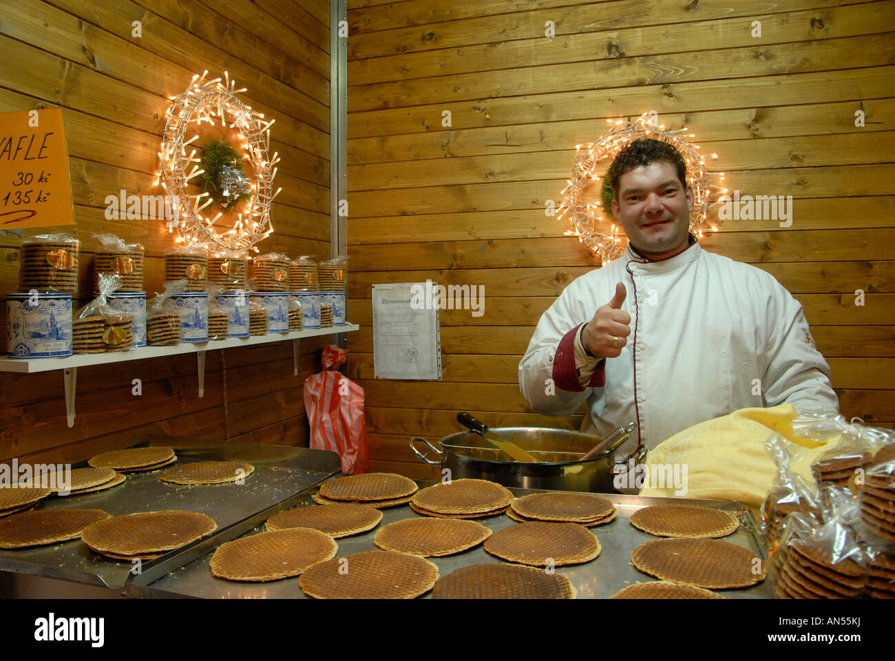 A man selling giant waffles at a food stall in the traditional ...
