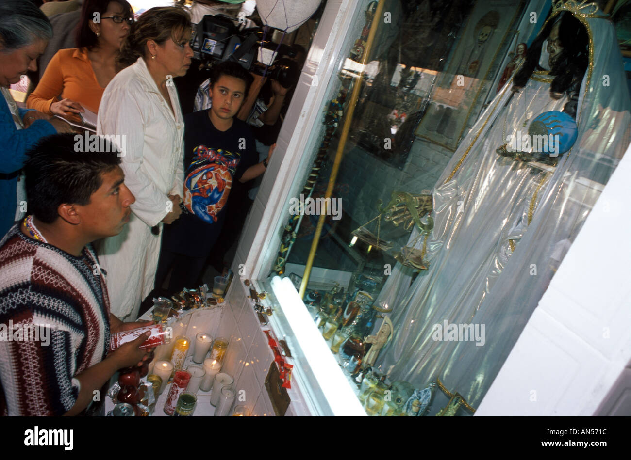A believer in the Mexican cult of the Santa Muerte or Holy Death prays ...