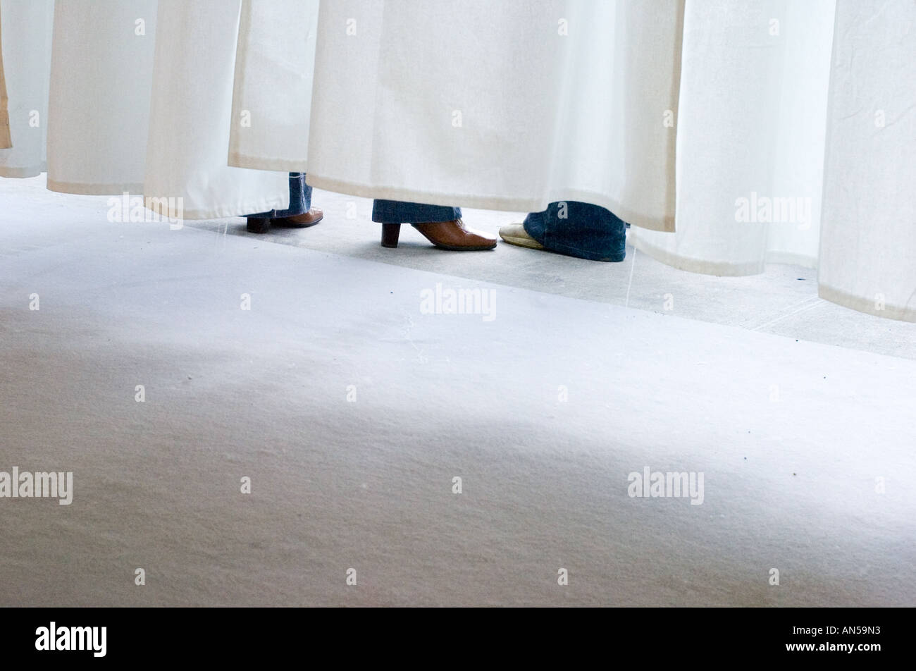 couple s feet hiding behind tent Stock Photo - Alamy