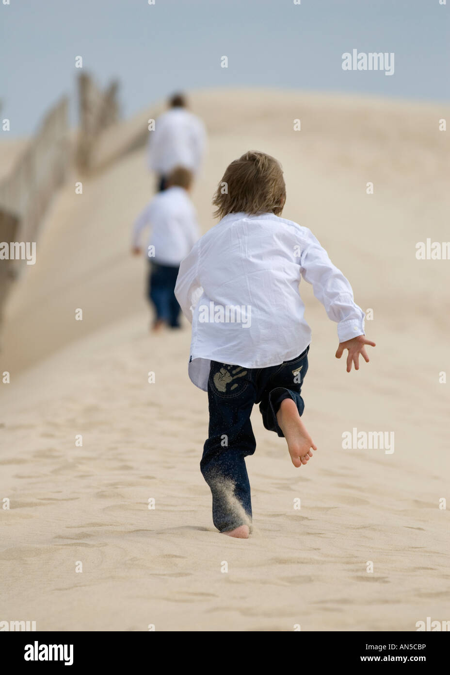 Boy Running On Sand Dune High Resolution Stock Photography and Images ...