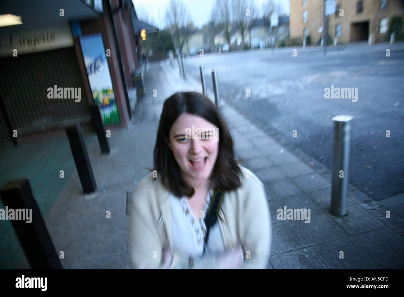 Lady smiles at bus stop Stock Photo - Alamy