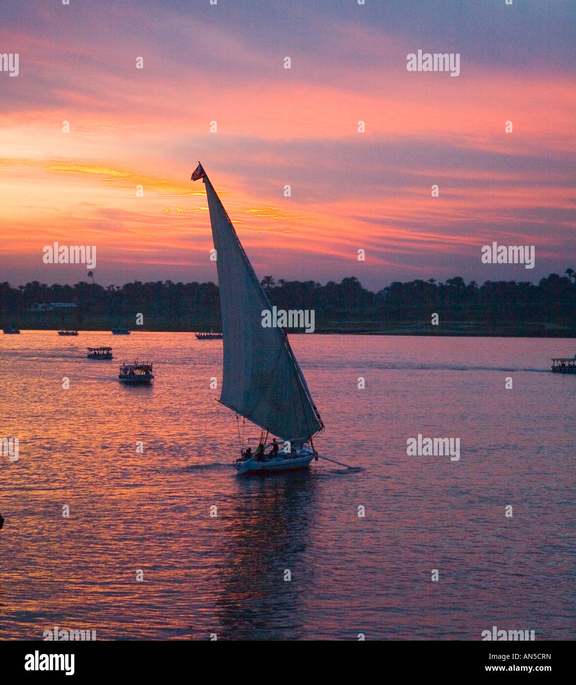 Luxor at sunset with Feluccas sailing on the Nile Stock Photo - Alamy