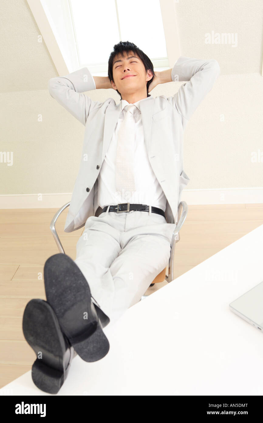Office worker riding his foot on a desk Stock Photo - Alamy