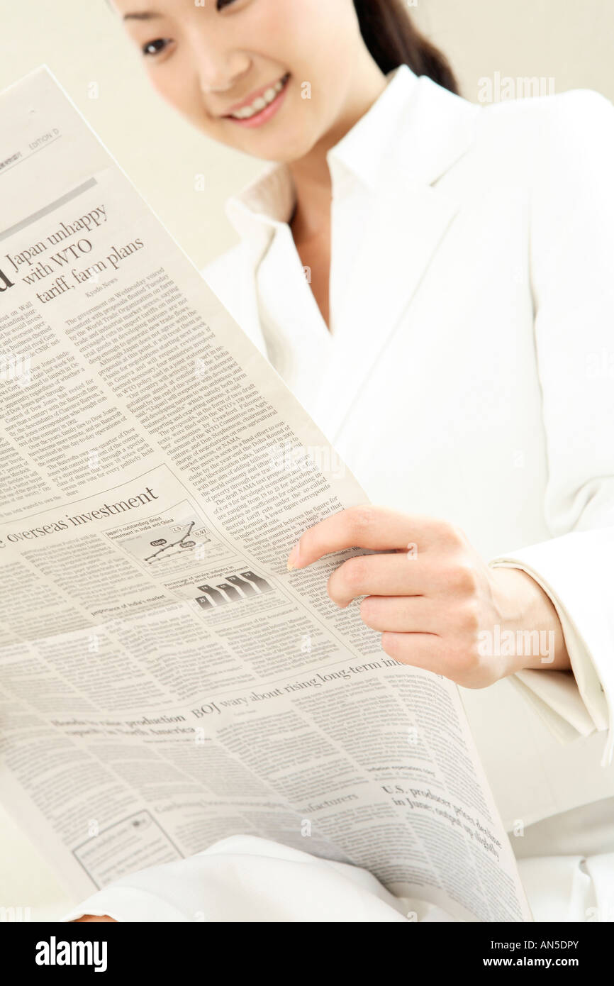 Office lady reading a newspaper Stock Photo - Alamy