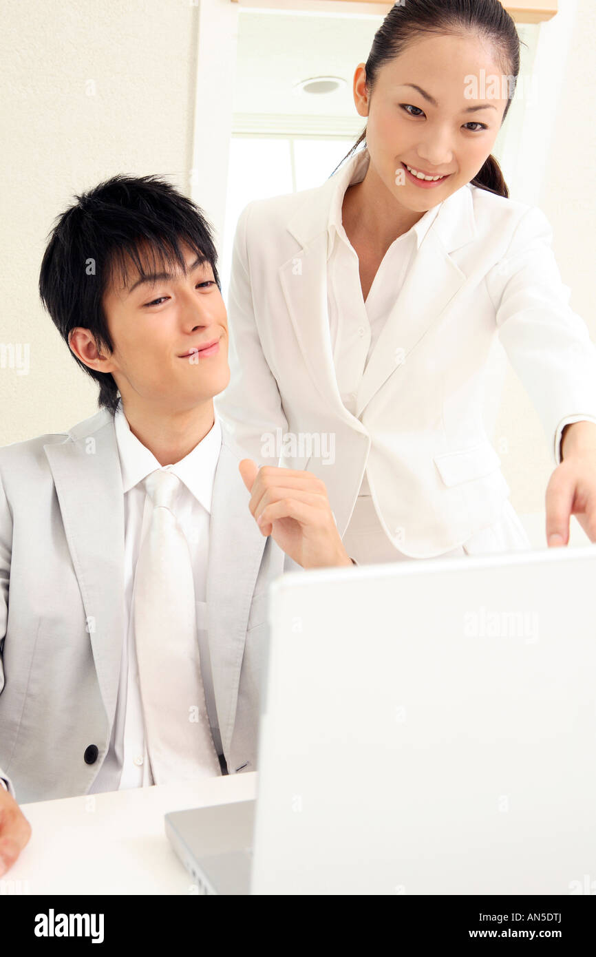 Office workers looking at PC monitor Stock Photo - Alamy
