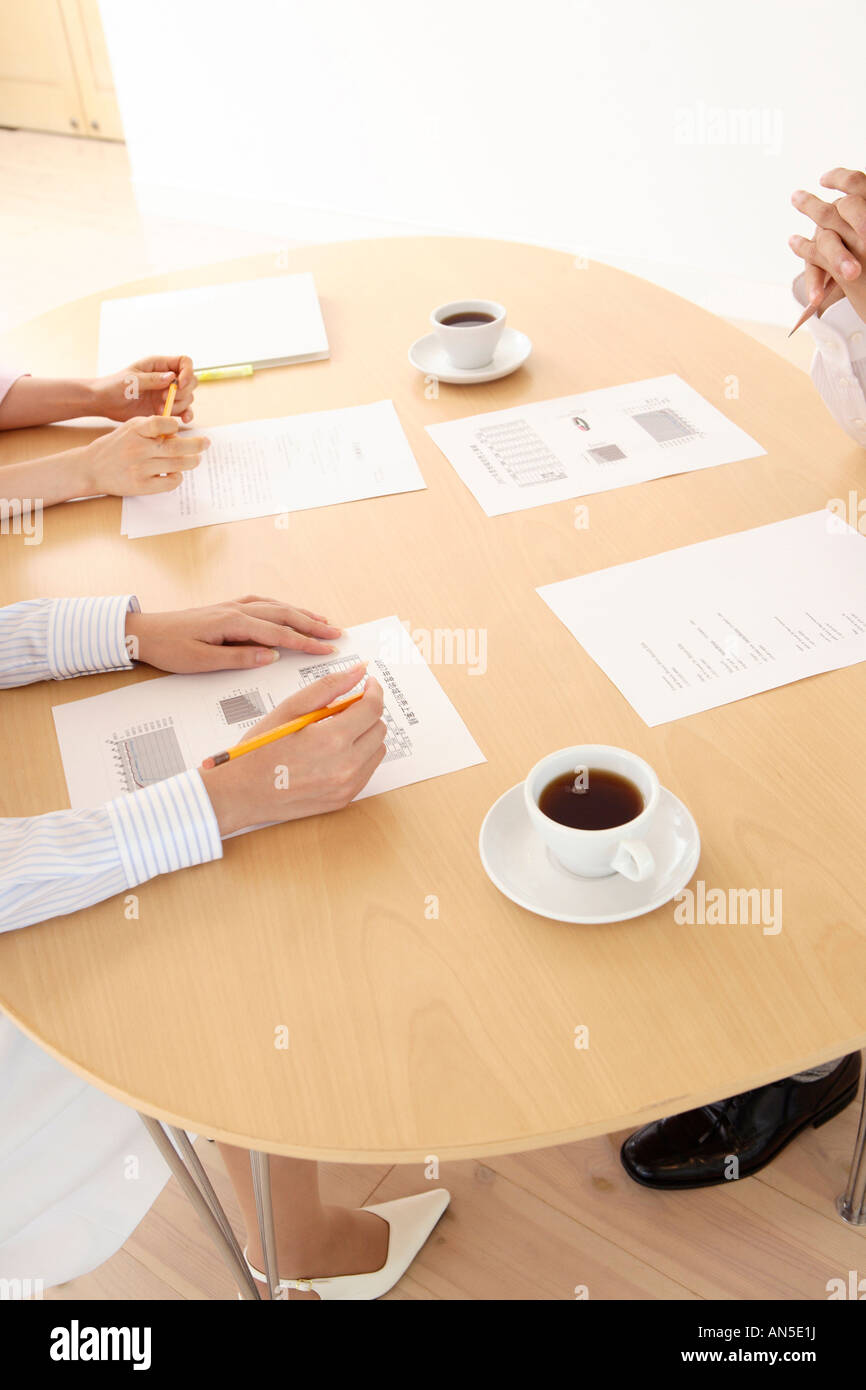 Office workers having a brief meeting Stock Photo - Alamy