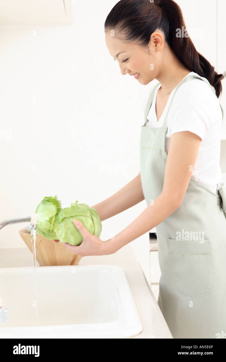 Woman washing cabbage Stock Photo - Alamy