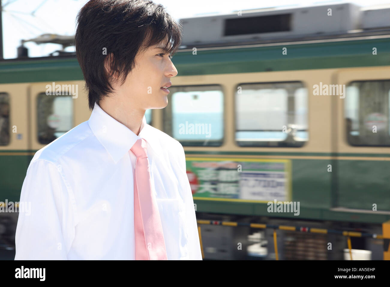 Japanese office worker waiting for passing train Stock Photo - Alamy