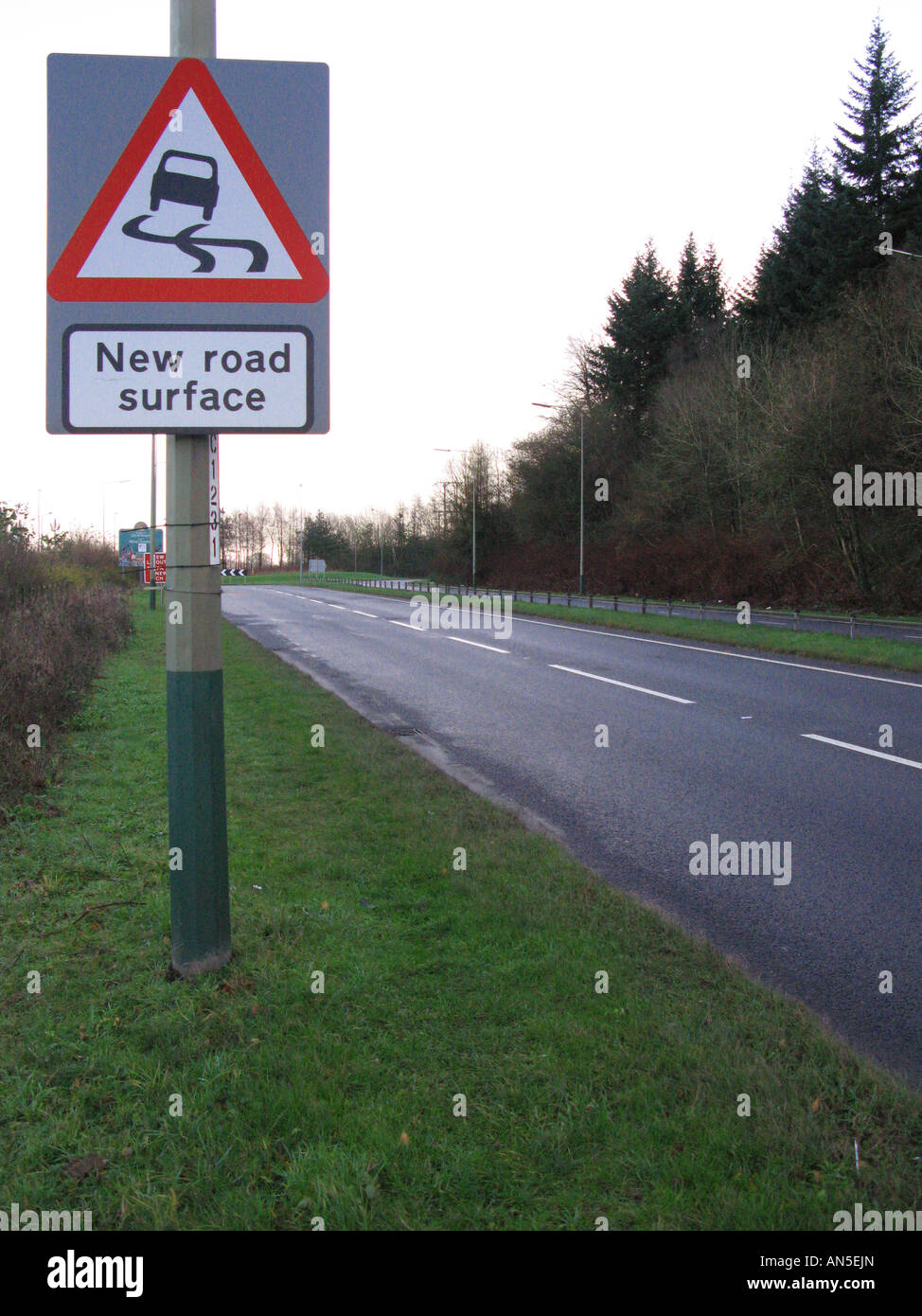 A sign warning motorists that there is a new road surface ahead Stock ...