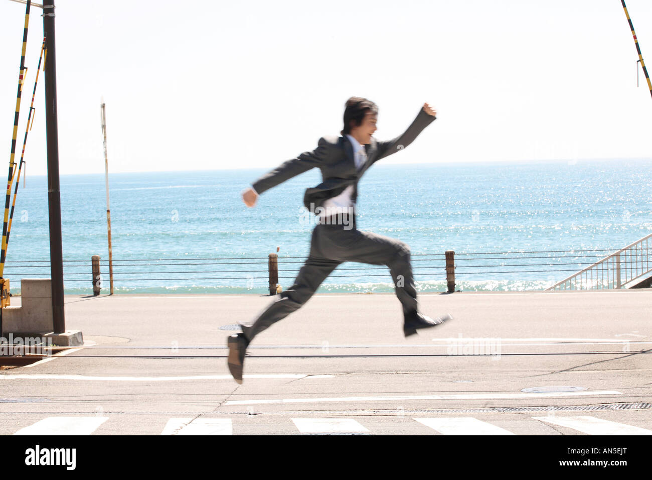 A Japanese office worker Jumping Running Stock Photo - Alamy