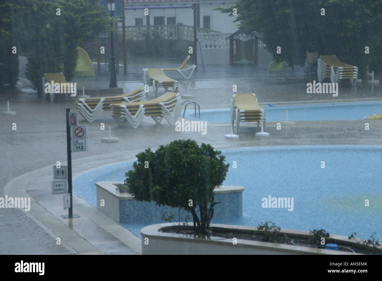 Very heavy rain falling on the swimming pool at a hotel in Menorca ...