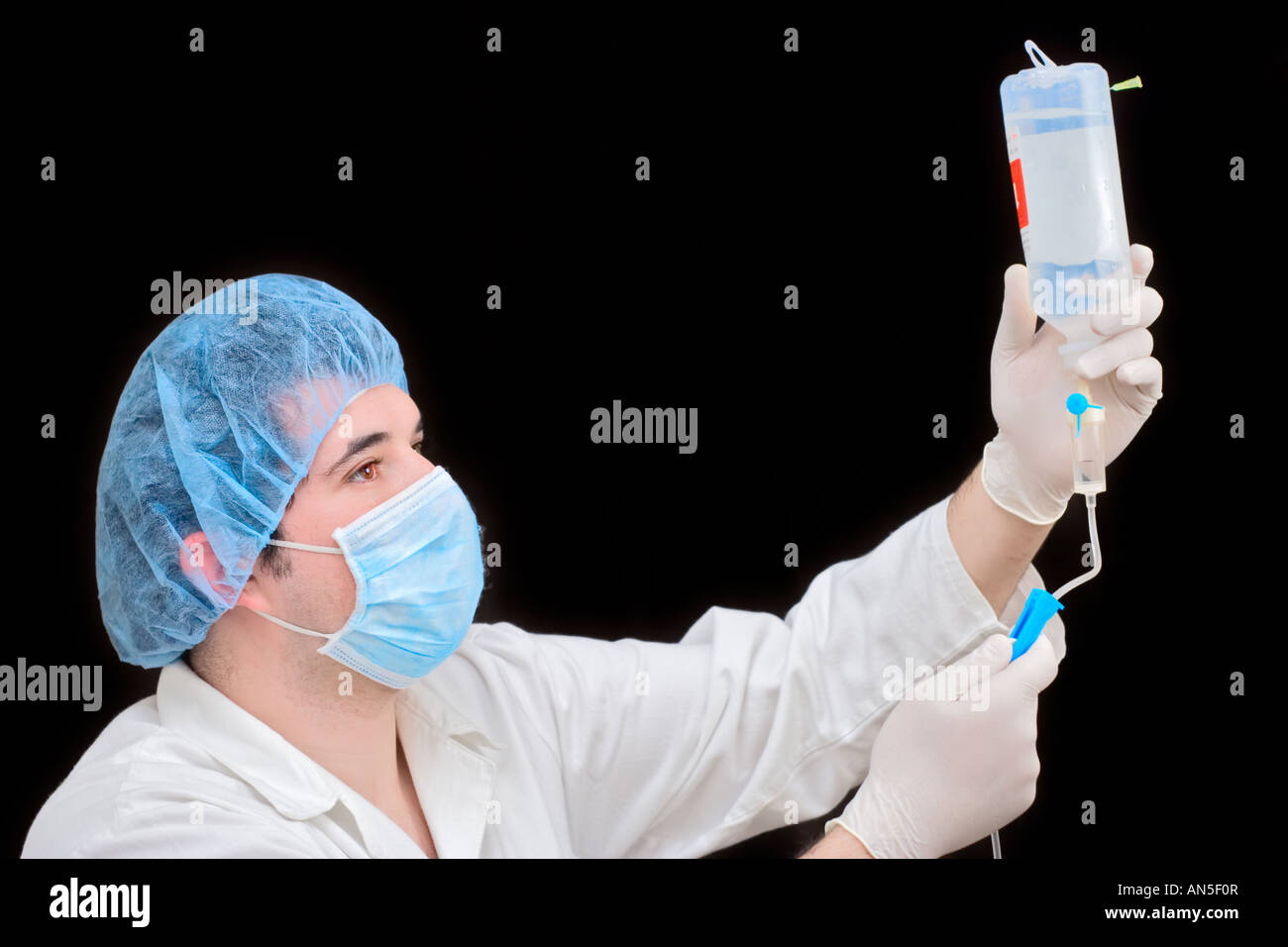 Ambulance worker examining infusion Stock Photo - Alamy