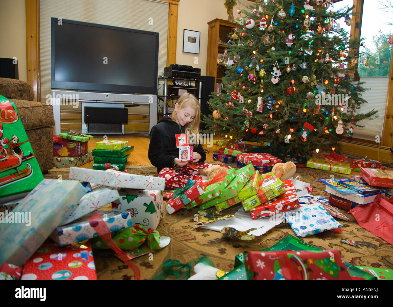 Child opening her Christmas presents Stock Photo - Alamy