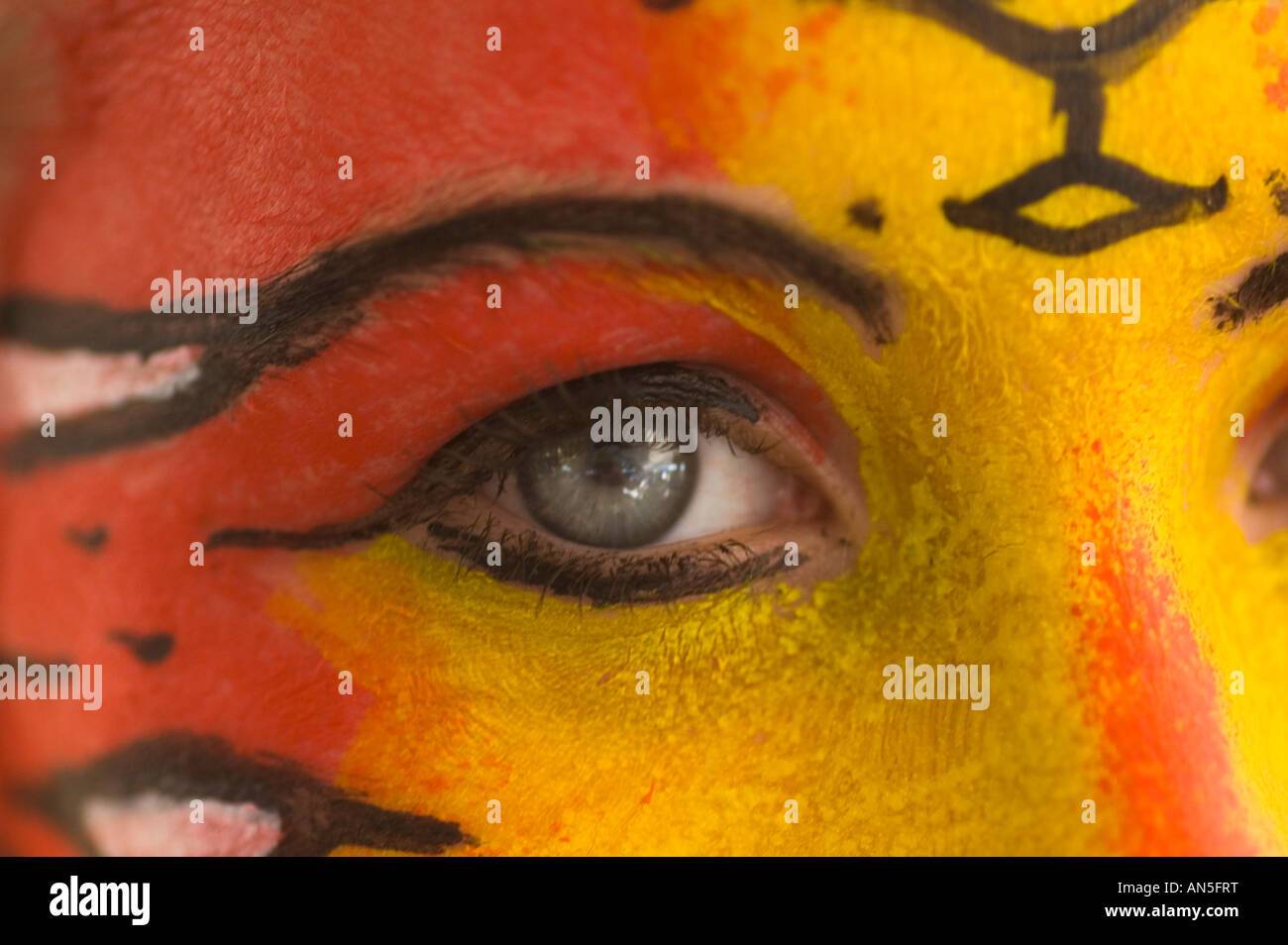 beautiful blue eyed girl with yellow face paint Stock Photo - Alamy