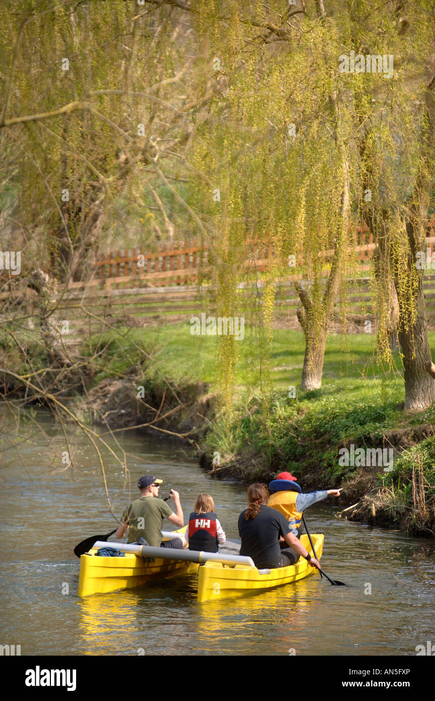 A FATHER WITH HIS TWO CHILDREN AND A GUIDE PADDLE DOWN THE RIVER THAMES ...