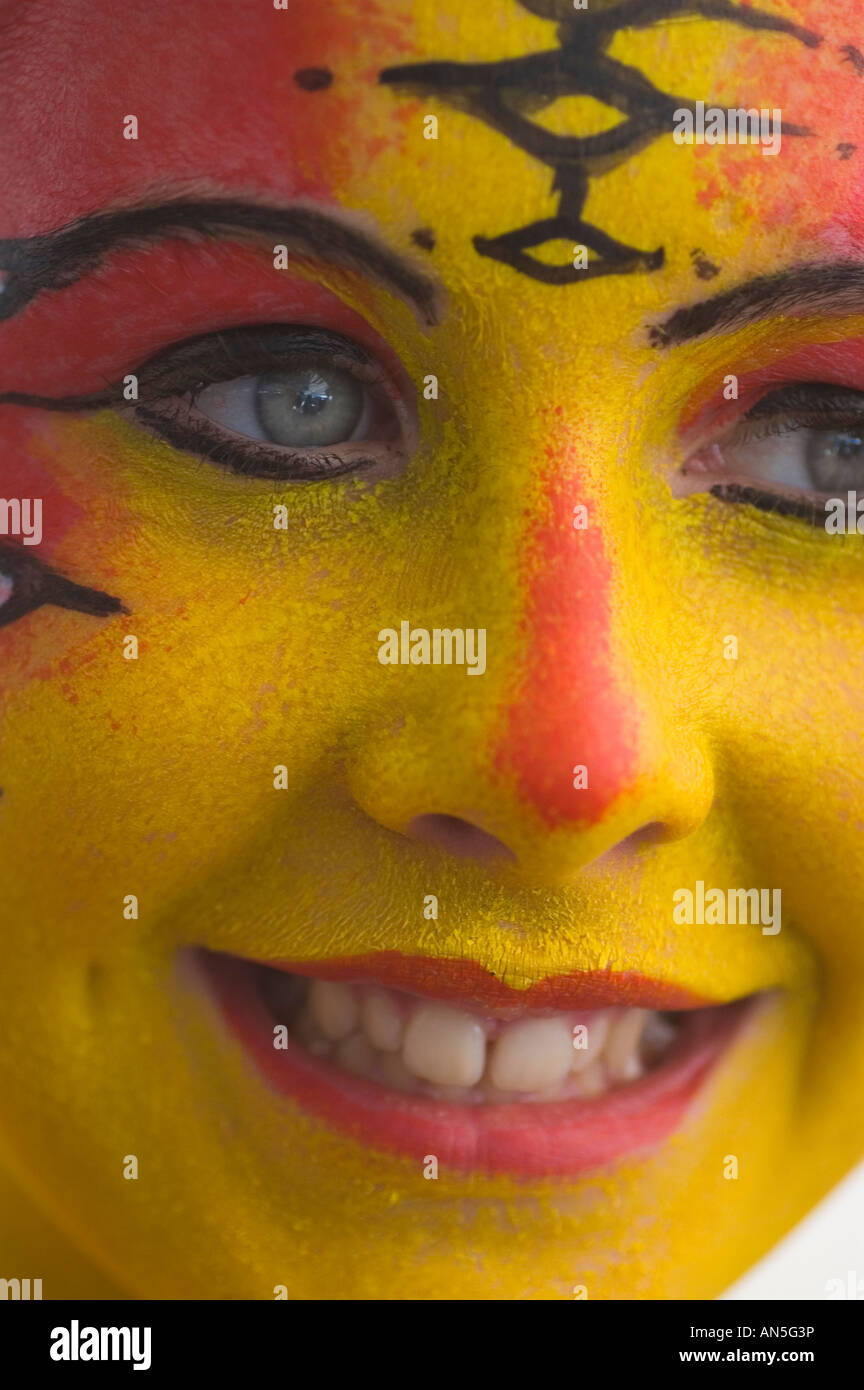 beautiful blue eyed girl with yellow face paint Stock Photo - Alamy