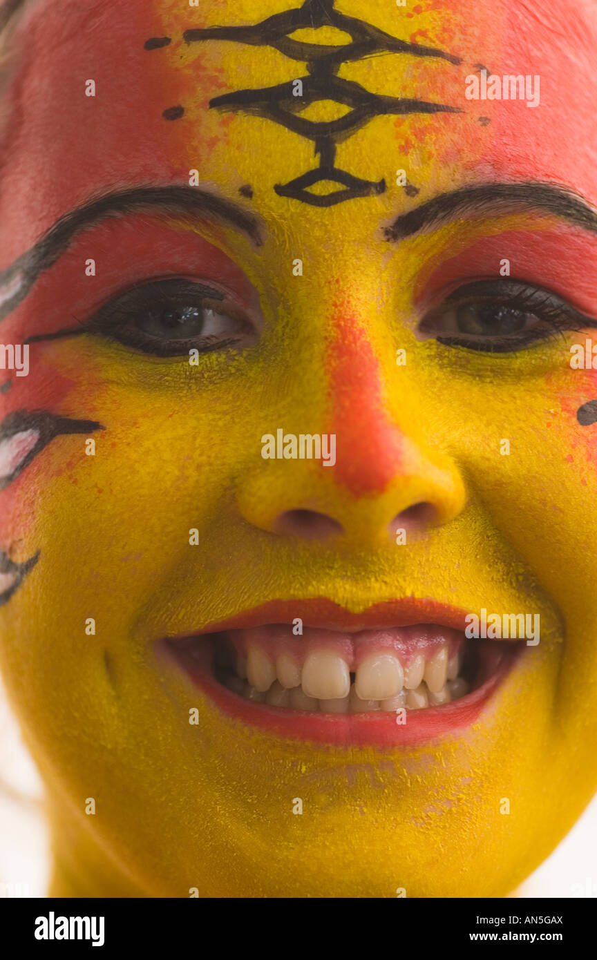 beautiful blue eyed girl with yellow face paint Stock Photo - Alamy