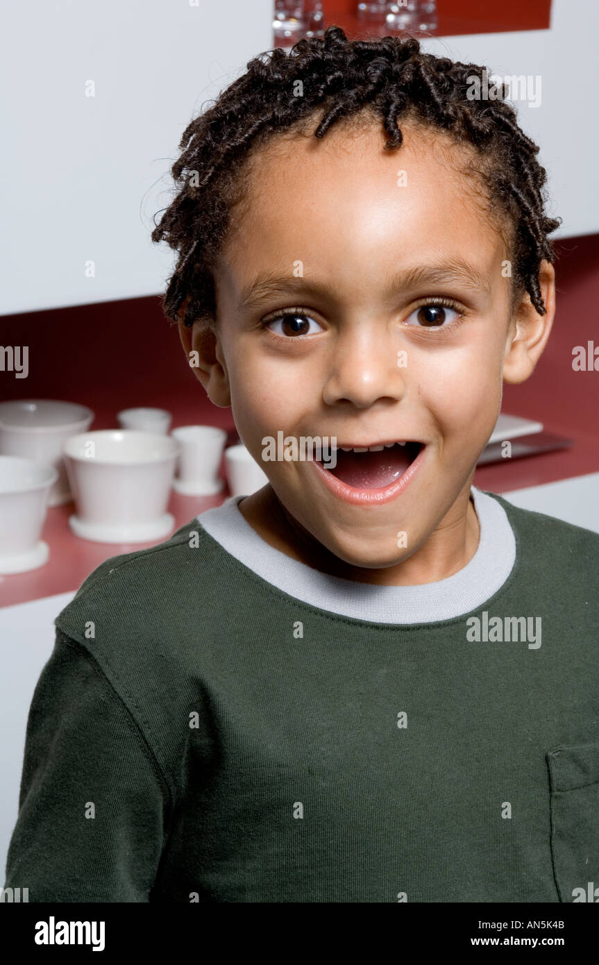 Portrait of a young boy acting shocked Stock Photo - Alamy